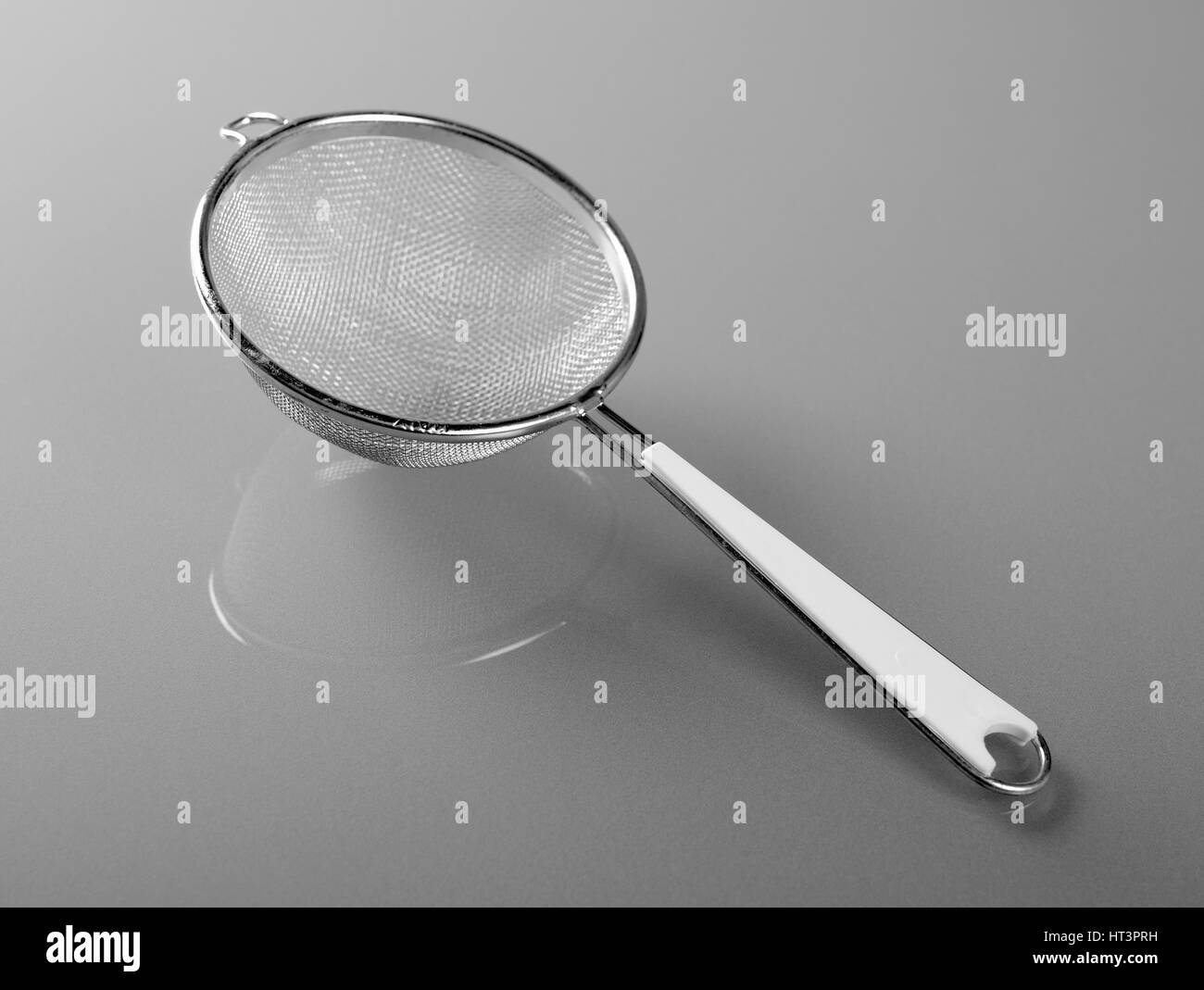 Metallic strainer with plastic handle, a modern kitchen utensil Stock ...