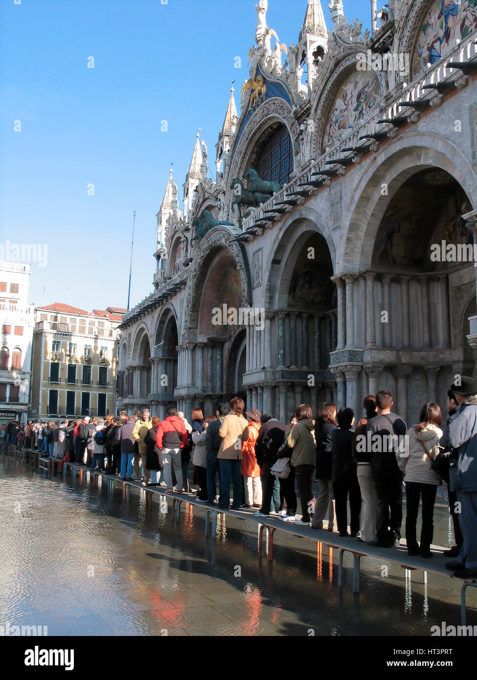 Piazza San Marco experiences acqua alta as visitors navigate flooded ...