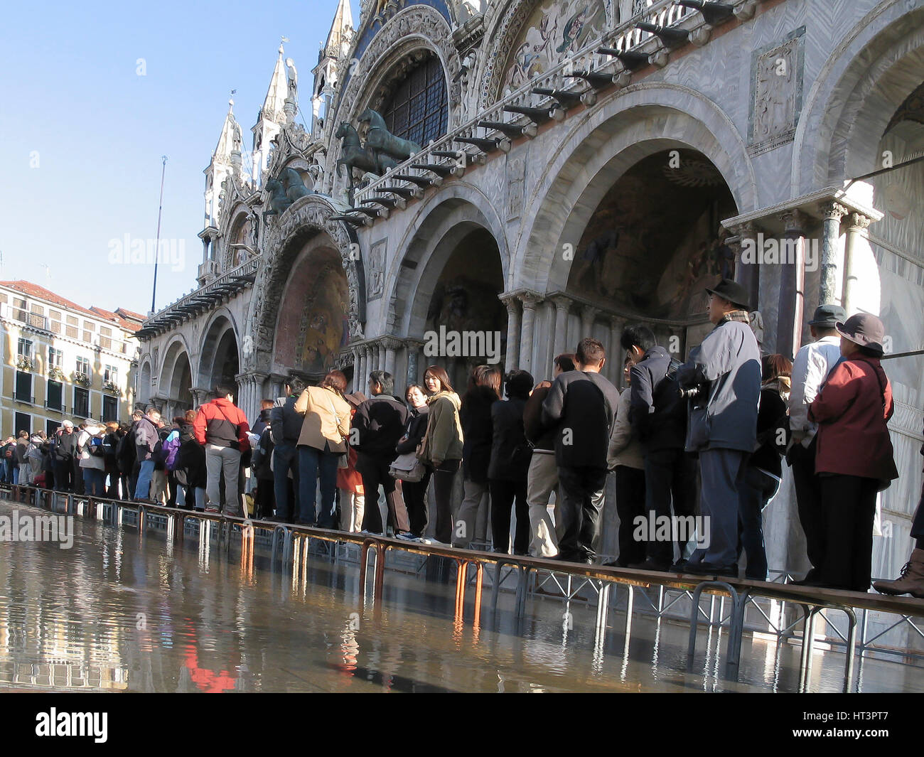 Piazza San Marco experiences acqua alta as visitors navigate flooded ...