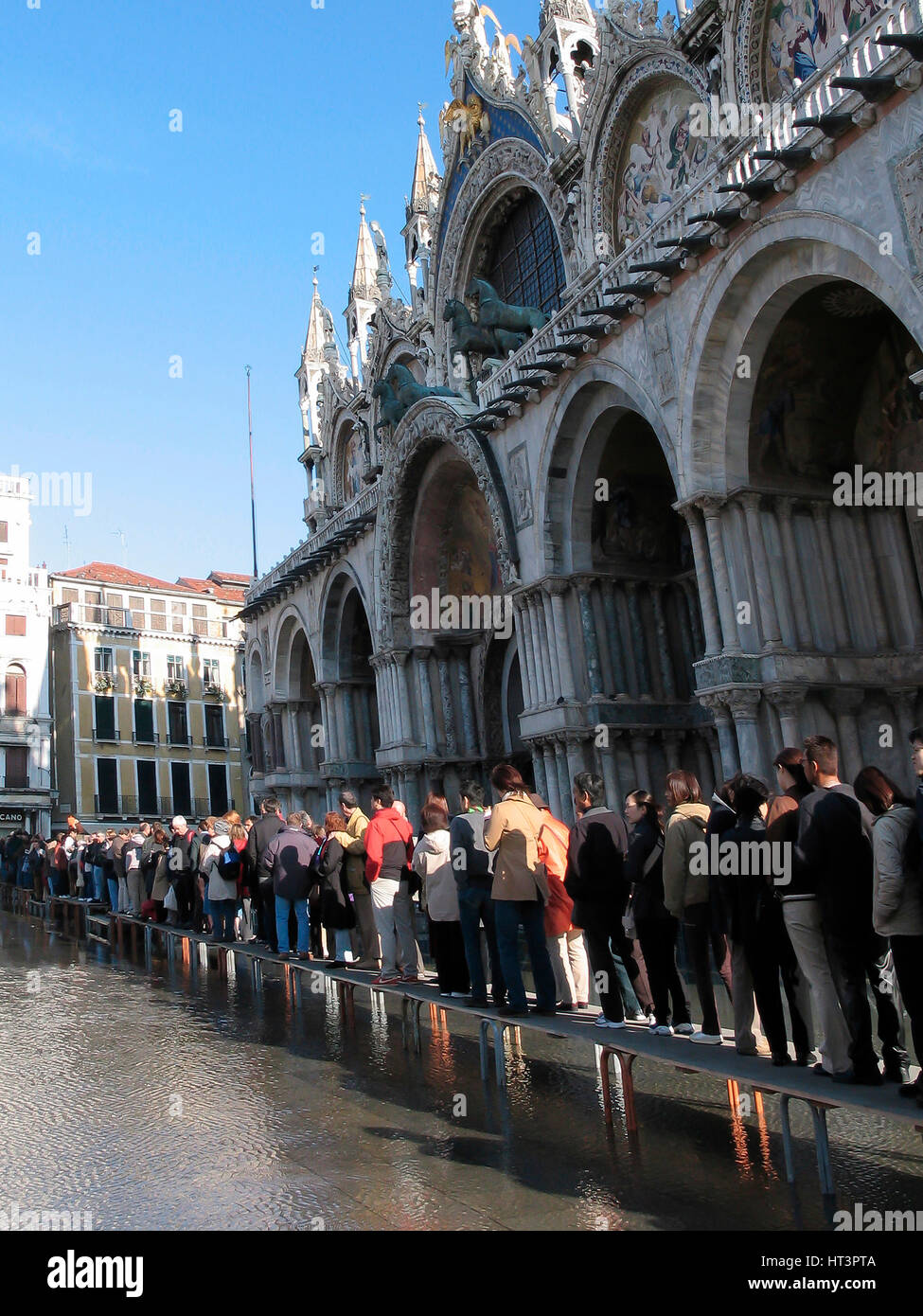 Piazza San Marco experiences acqua alta as visitors navigate flooded ...