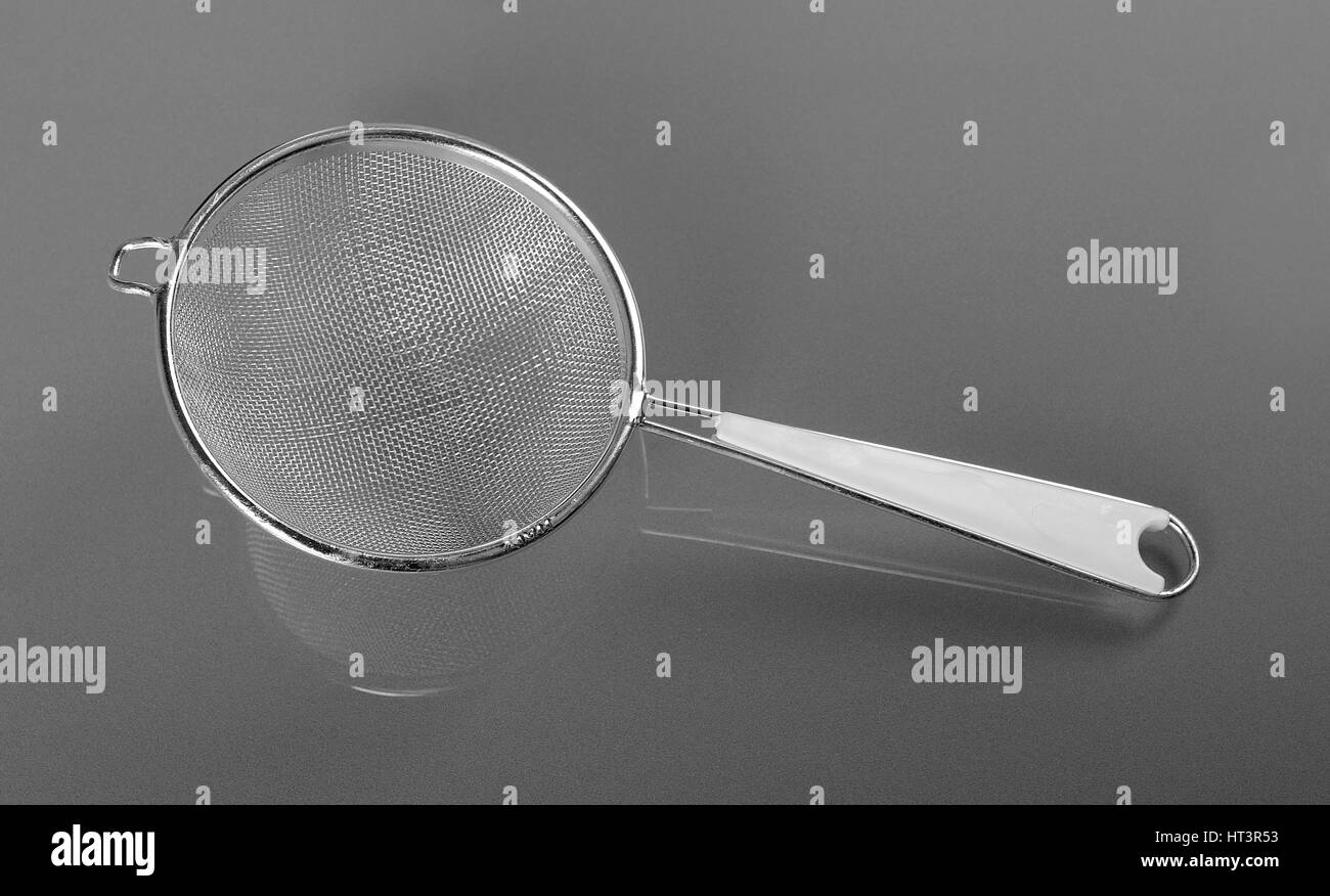 Metallic strainer with plastic handle, a modern kitchen utensil Stock ...