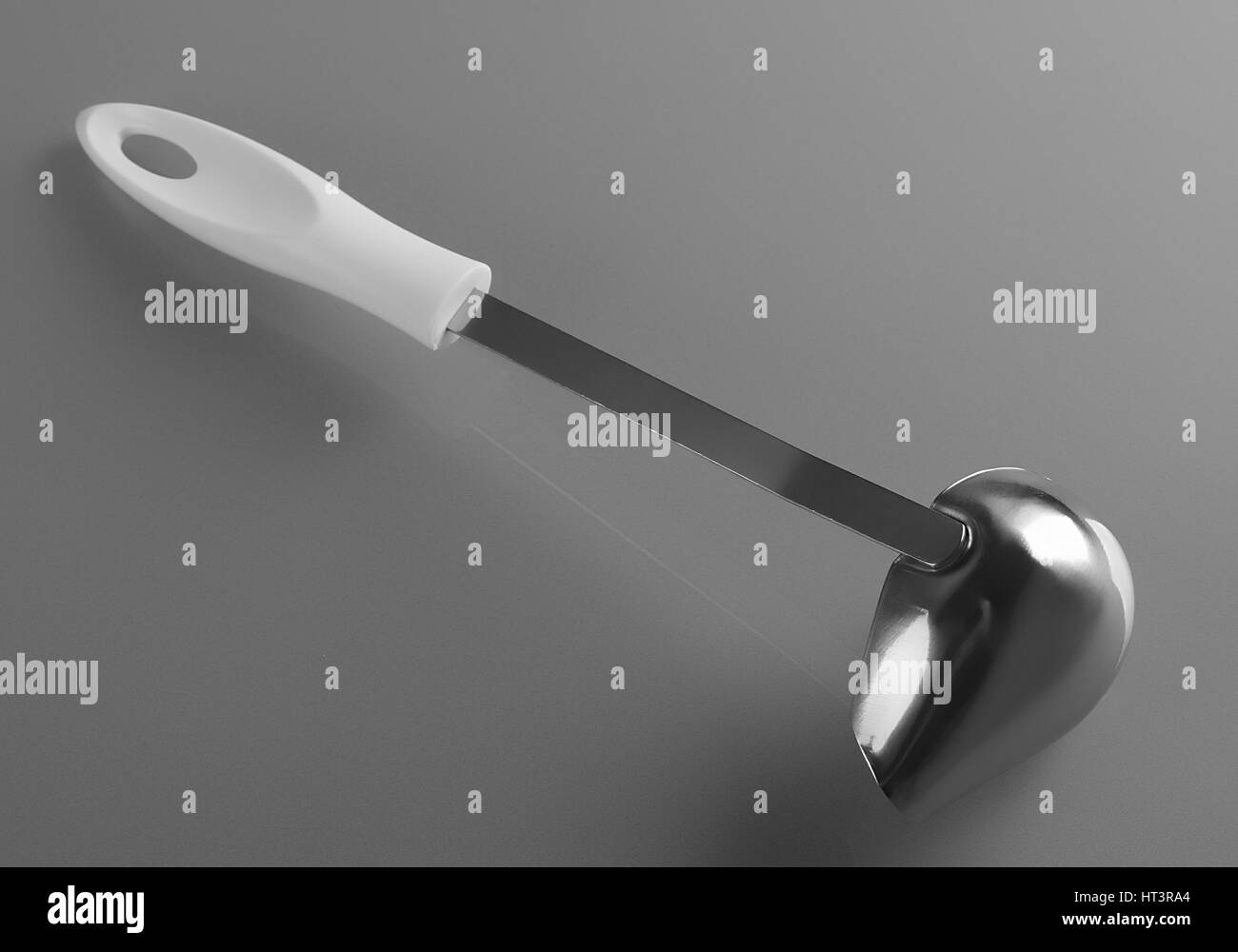 Silver soup ladle with plastic handle on gray background Stock Photo ...