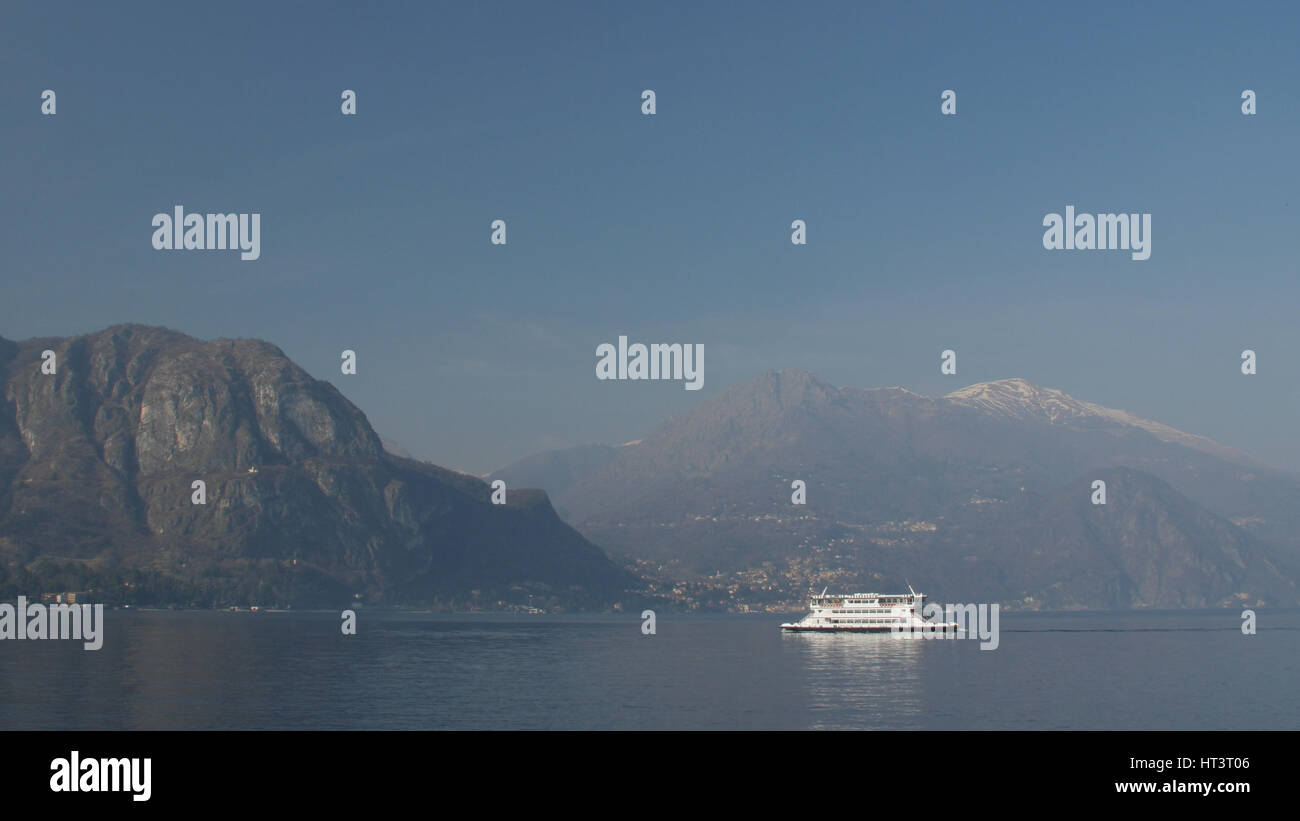 Ferry sailing through a mountain lake. Lake Como, Italy Stock Photo - Alamy