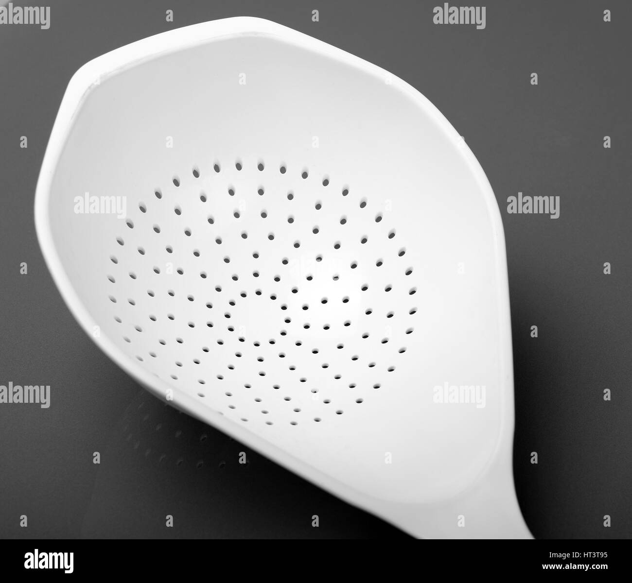 Close up of plastic strainer with handle, a modern kitchen utensil ...