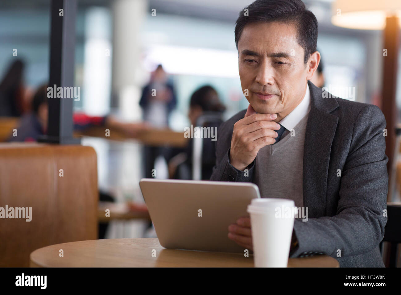 Businessman waiting in airport Stock Photo - Alamy