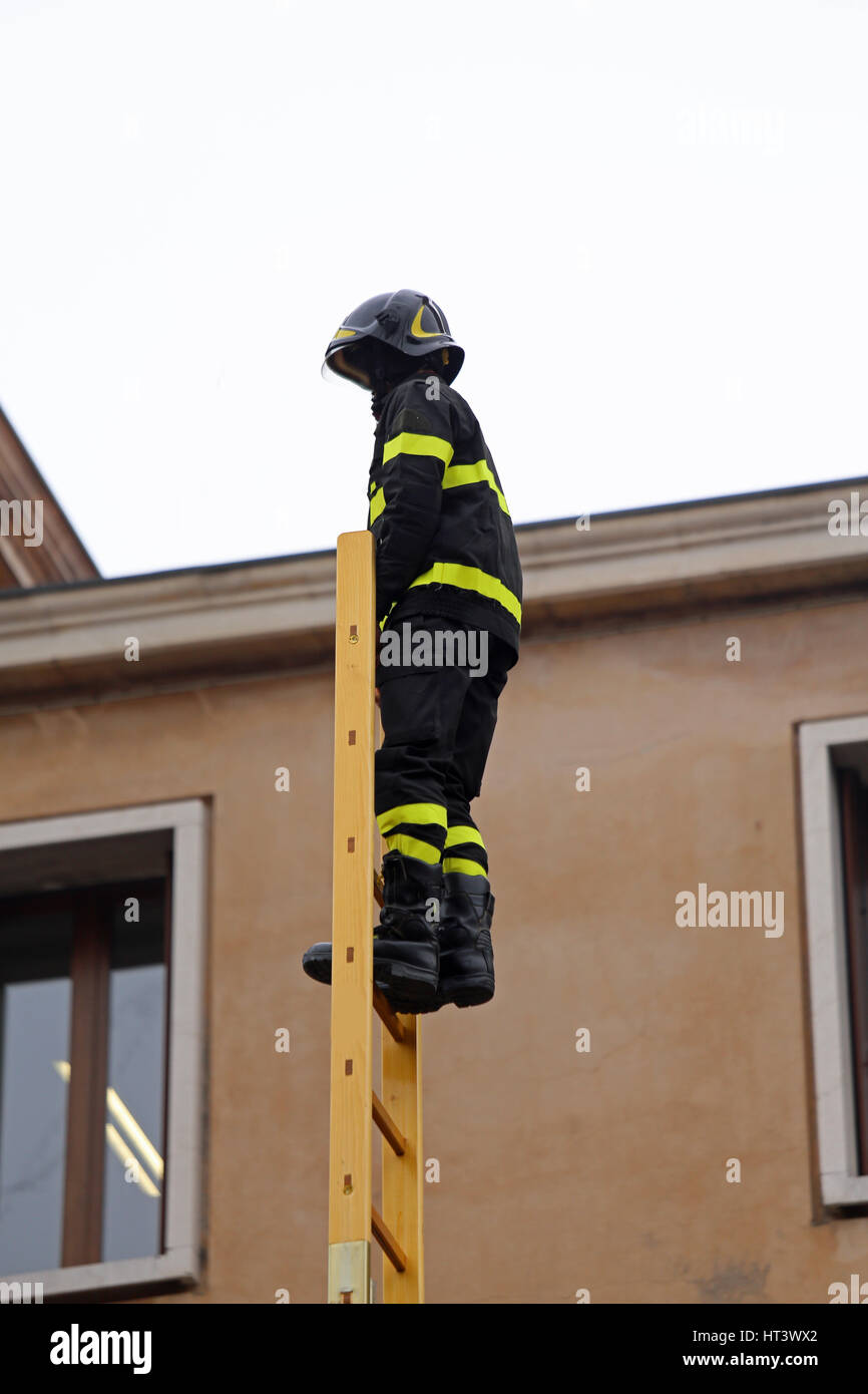 fearless firefighter over a high wooden staircase during a rescue ...