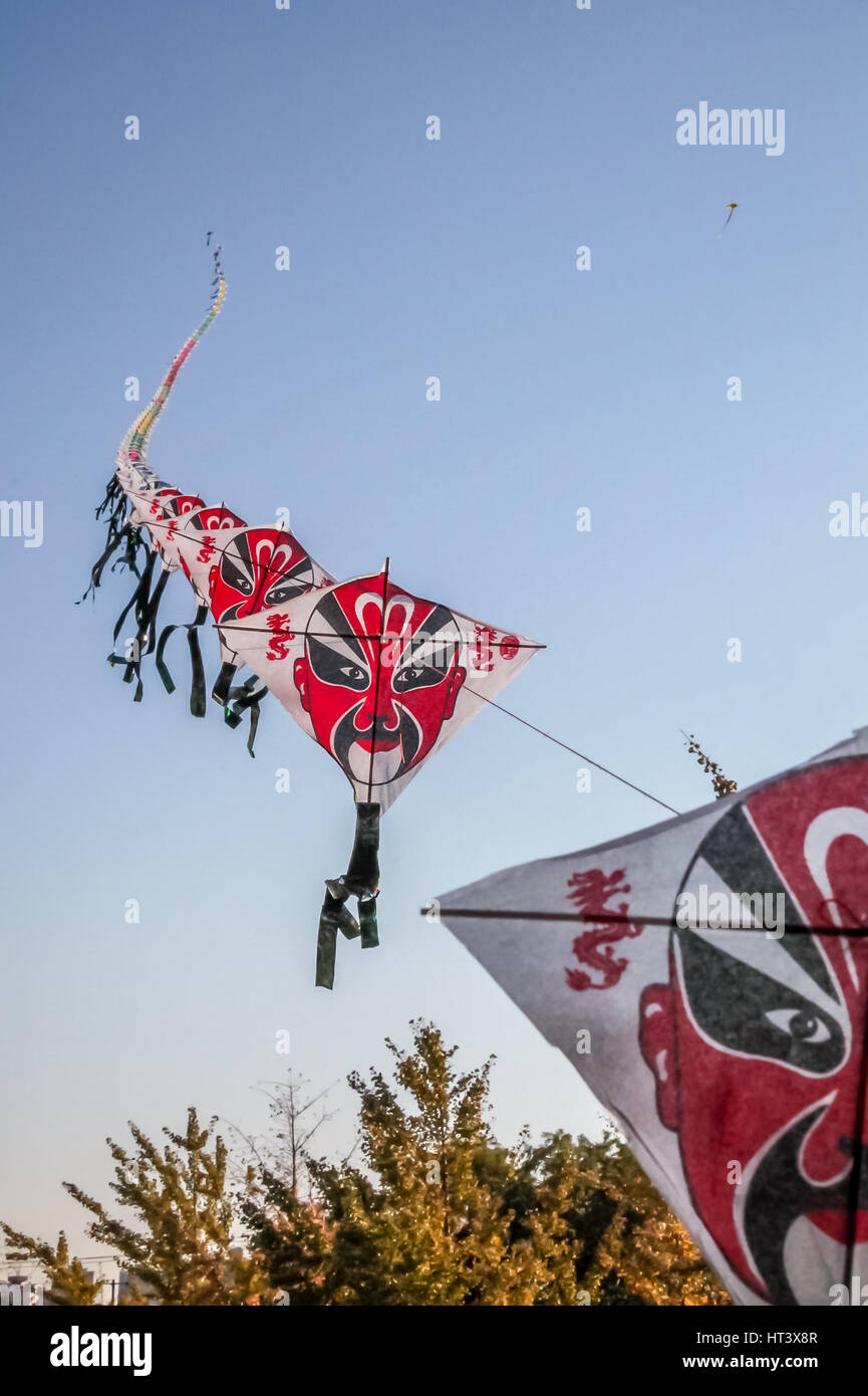 Row of chinese paper kites flying on clear blue sky Stock Photo - Alamy