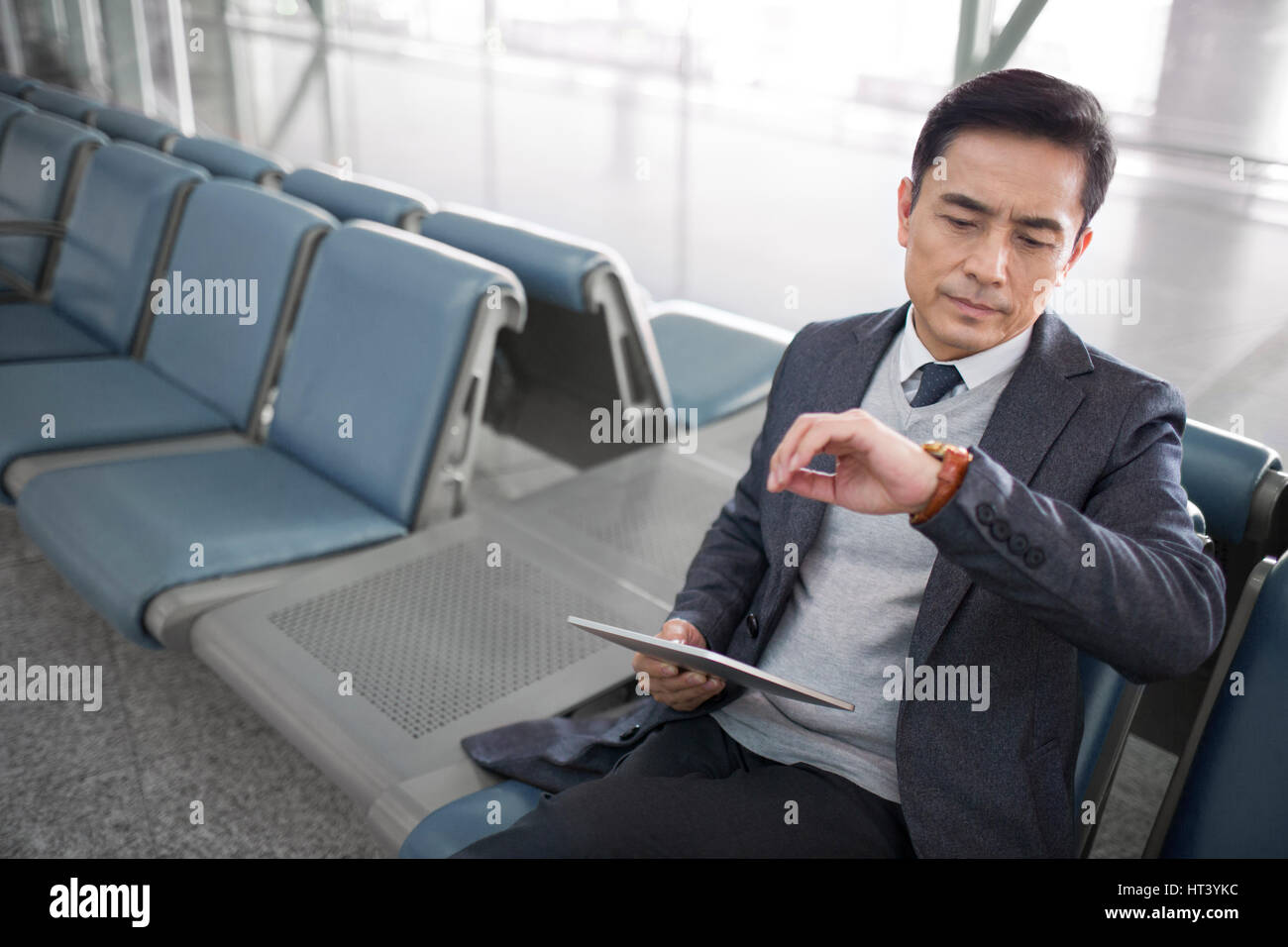 Businessman waiting in airport Stock Photo - Alamy