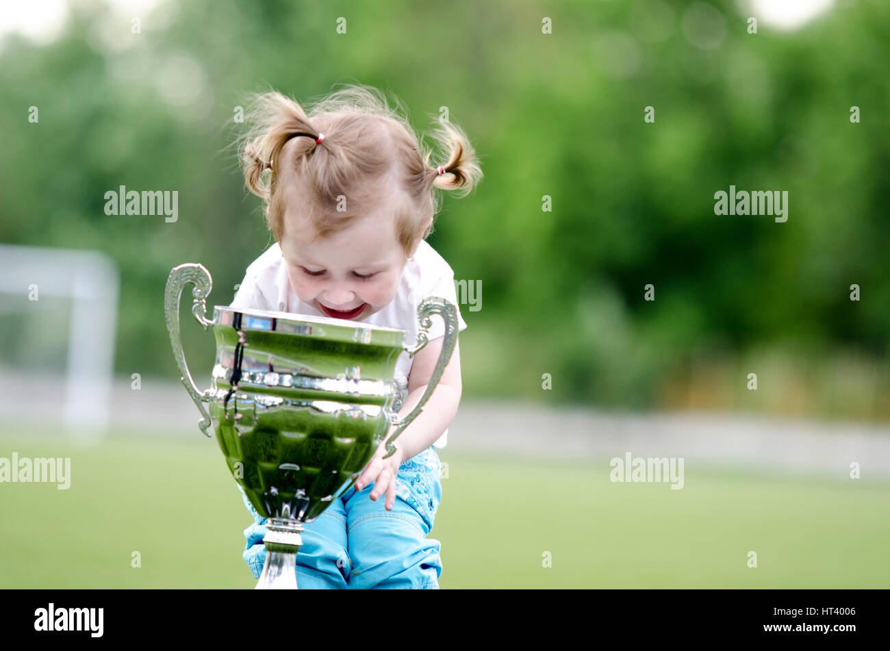 Girl showing winning trophy hi-res stock photography and images - Alamy