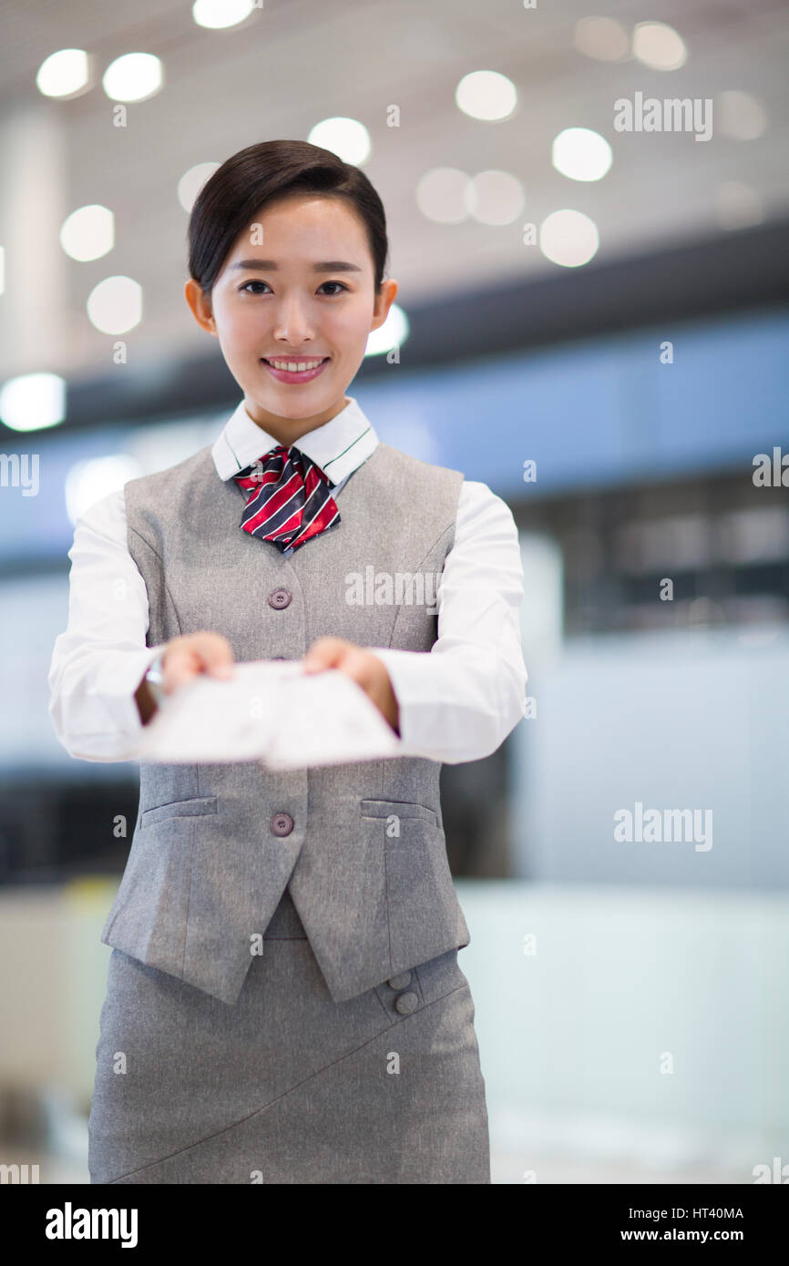 Smiling airline stewardess with airplane tickets Stock Photo - Alamy