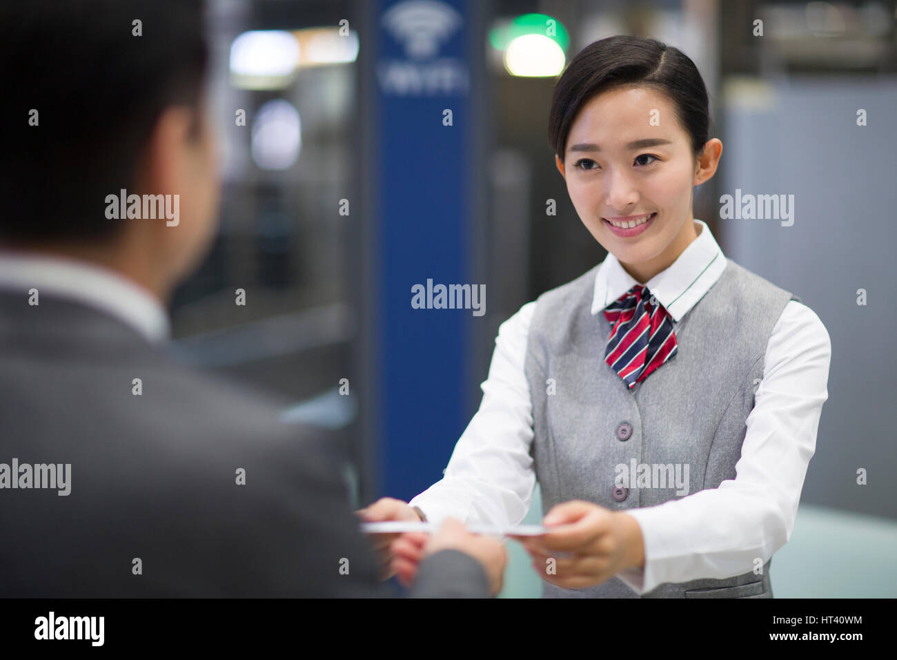 Smiling airline stewardess and passenger Stock Photo - Alamy