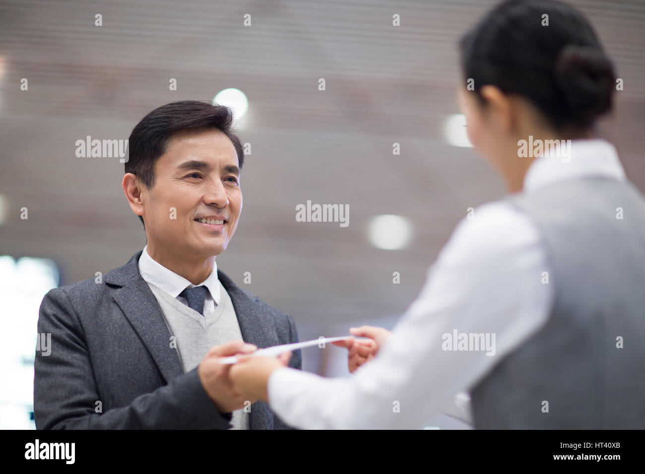Passenger and airline stewardess Stock Photo - Alamy