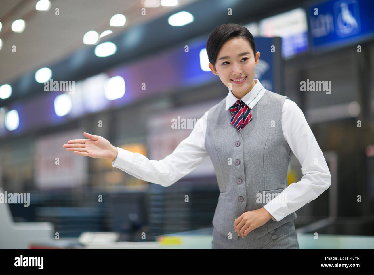 Smiling airline stewardess Stock Photo - Alamy