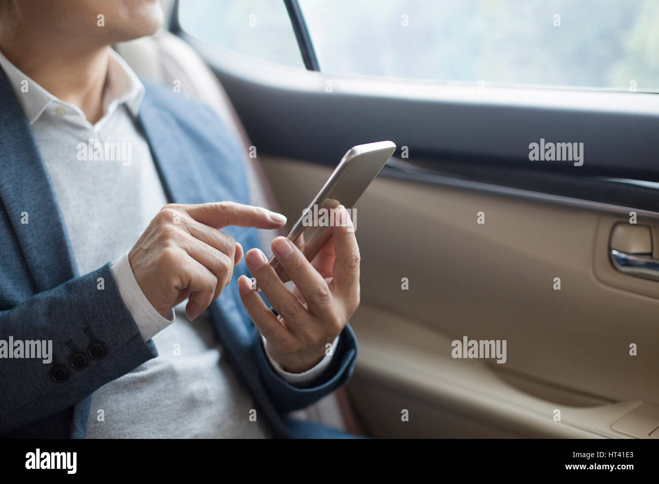 Businessman using smart phone inside car Stock Photo - Alamy
