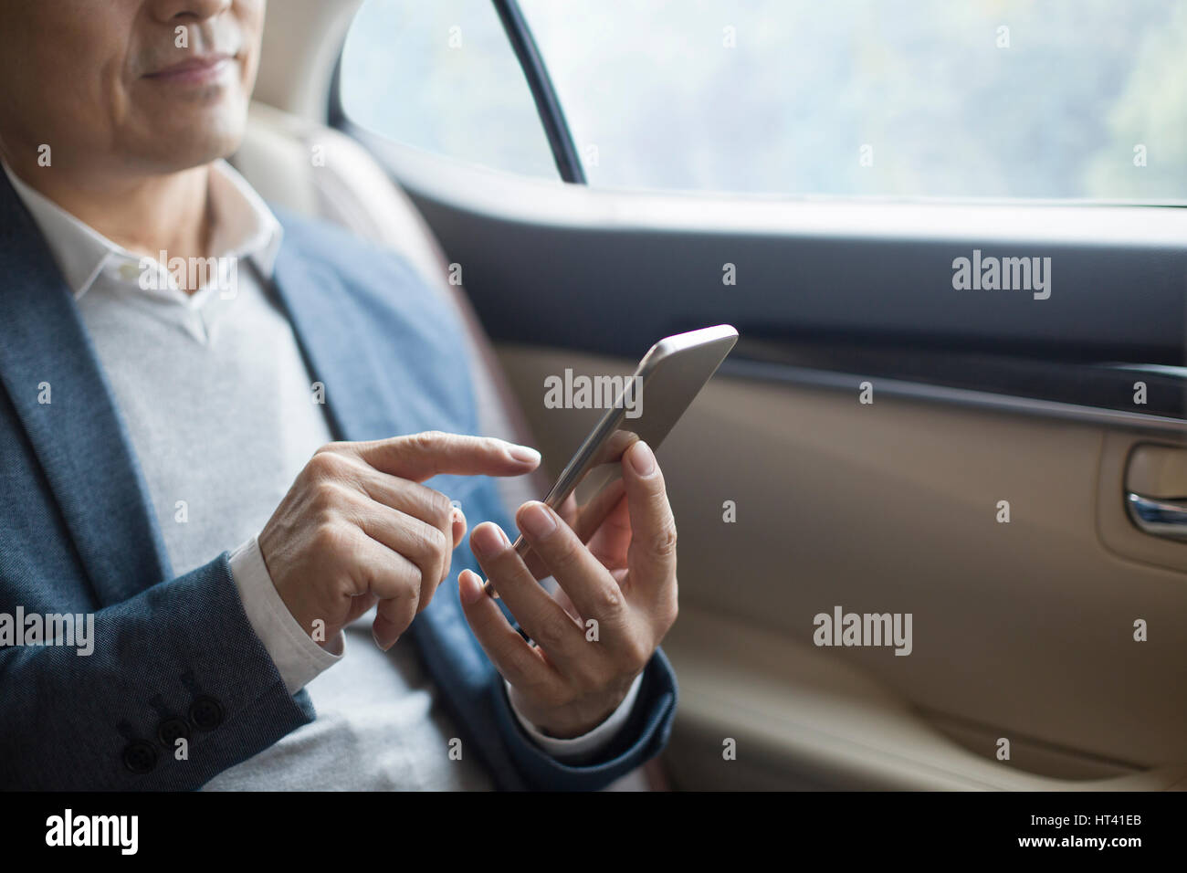 Businessman using smart phone inside car Stock Photo - Alamy