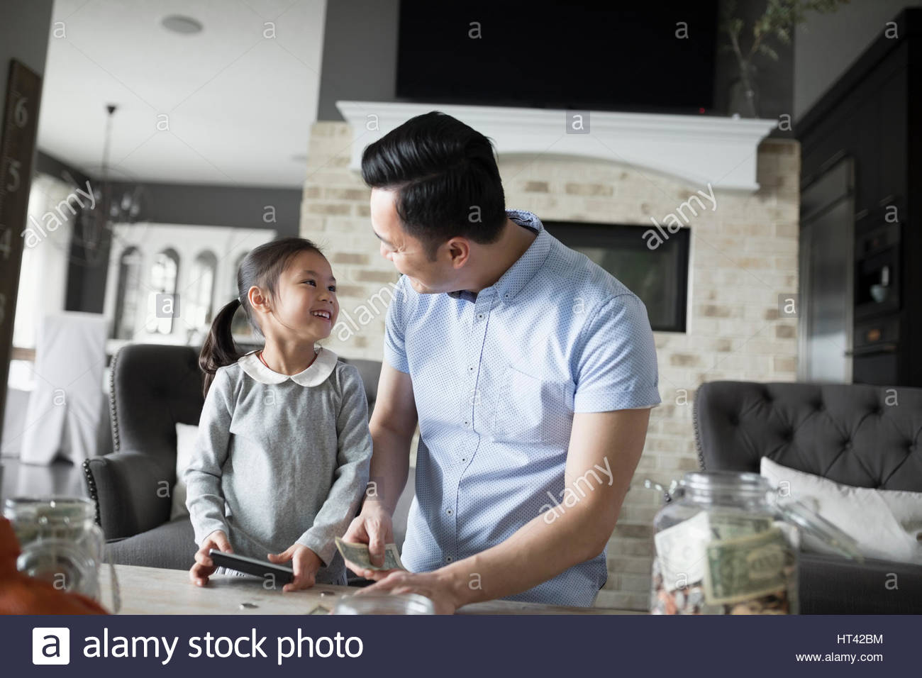 Black family counting cash hi-res stock photography and images - Alamy