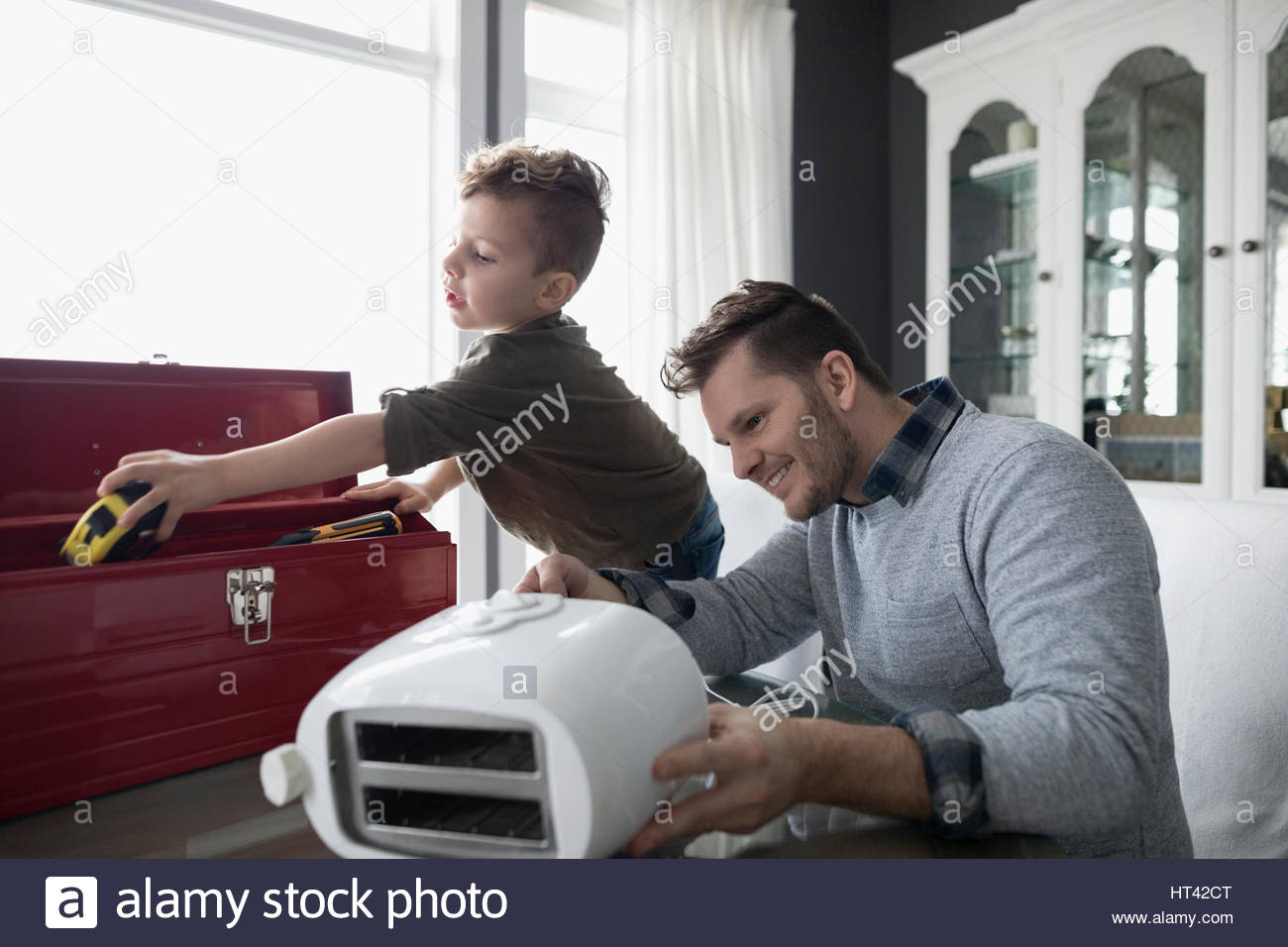 Father and son fixing toaster Stock Photo - Alamy