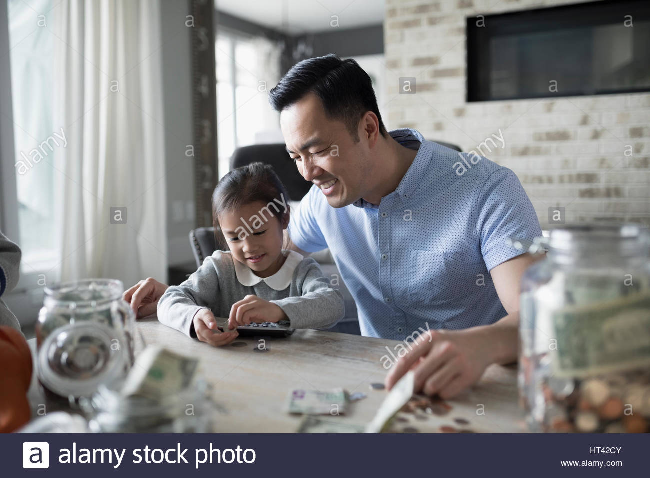 Father teaching daughter counting allowance money Stock Photo - Alamy