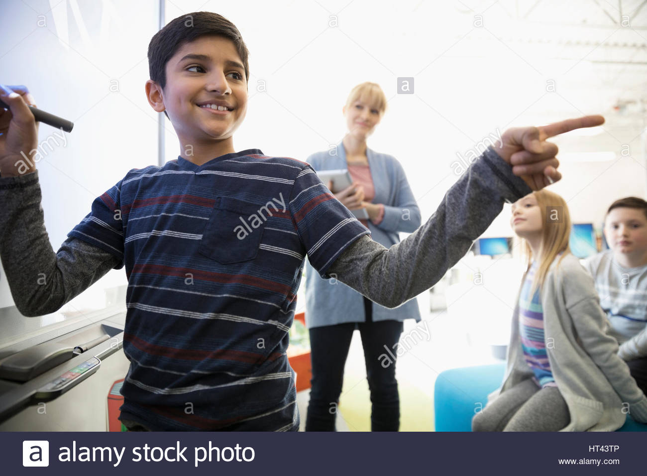 Child standing front whiteboard hi-res stock photography and images - Alamy