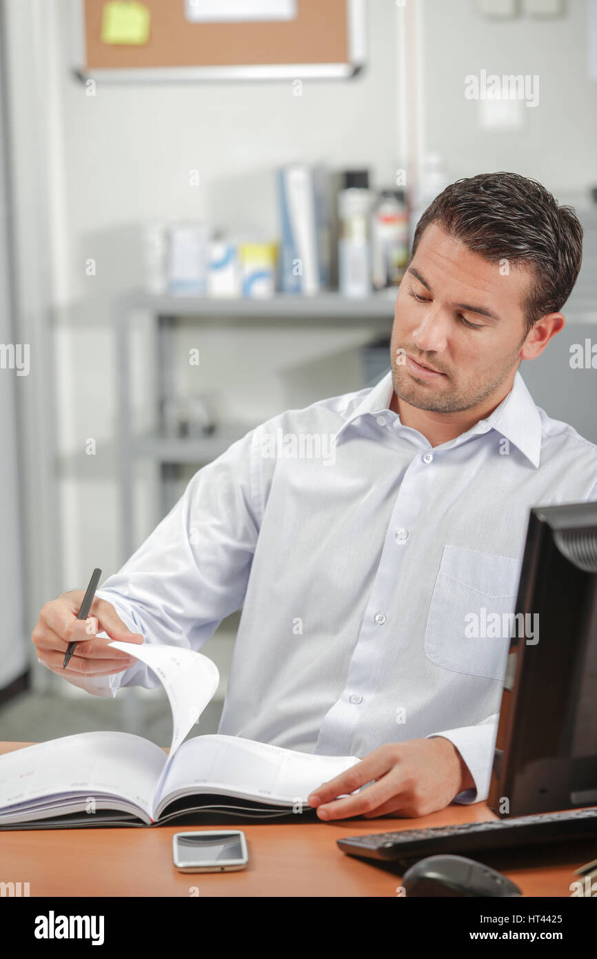 Reading at his desk Stock Photo - Alamy