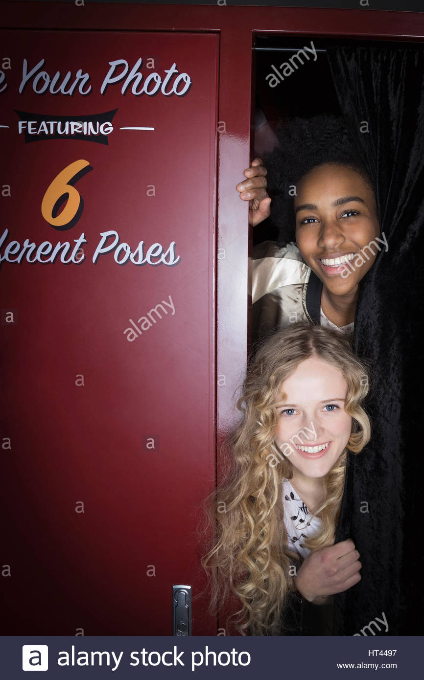 Portrait smiling young women friends in photo booth Stock Photo - Alamy