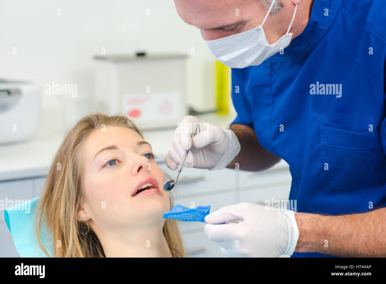 Dentist using mirror to see better Stock Photo - Alamy