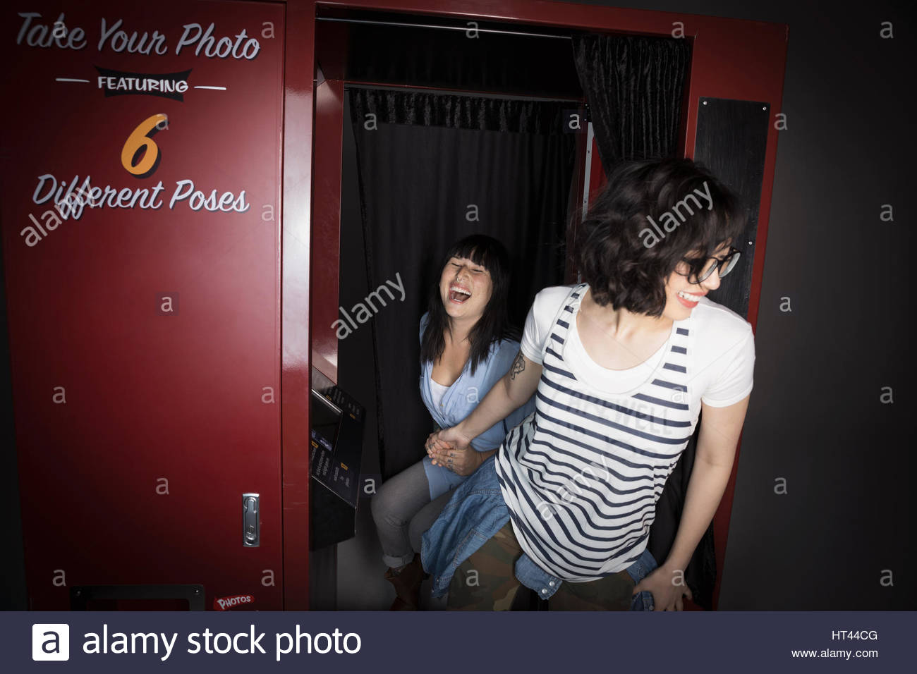 Two young people standing photo booth hi-res stock photography and ...
