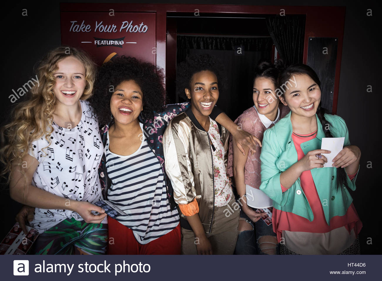 Portrait smiling young women friends at photo booth Stock Photo - Alamy