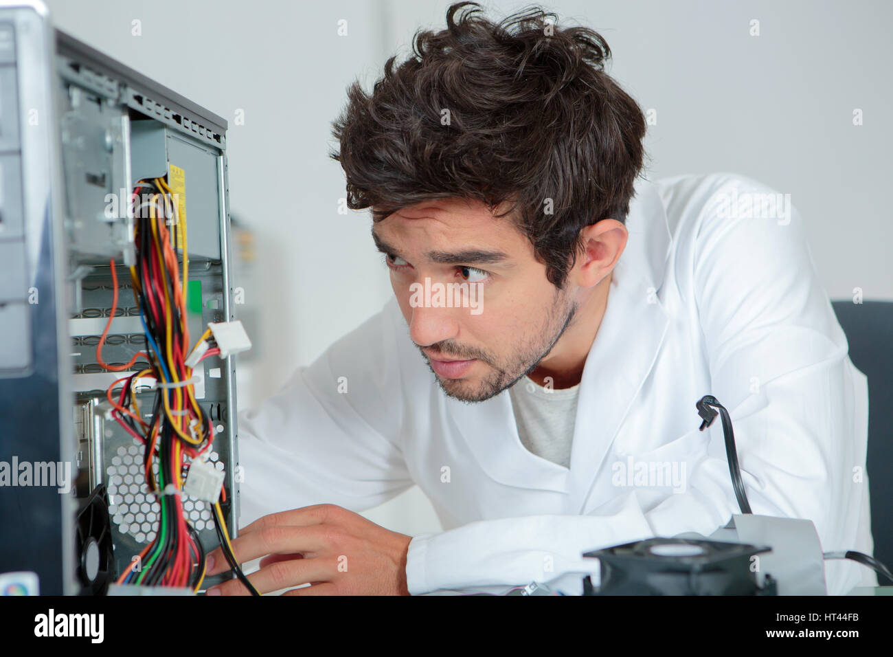Computer repairman looking confused Stock Photo - Alamy
