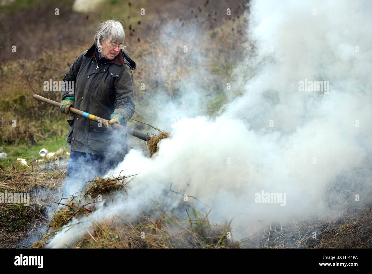 Volunteers help clear rubbish and brambles from a SSSI at the base of ...