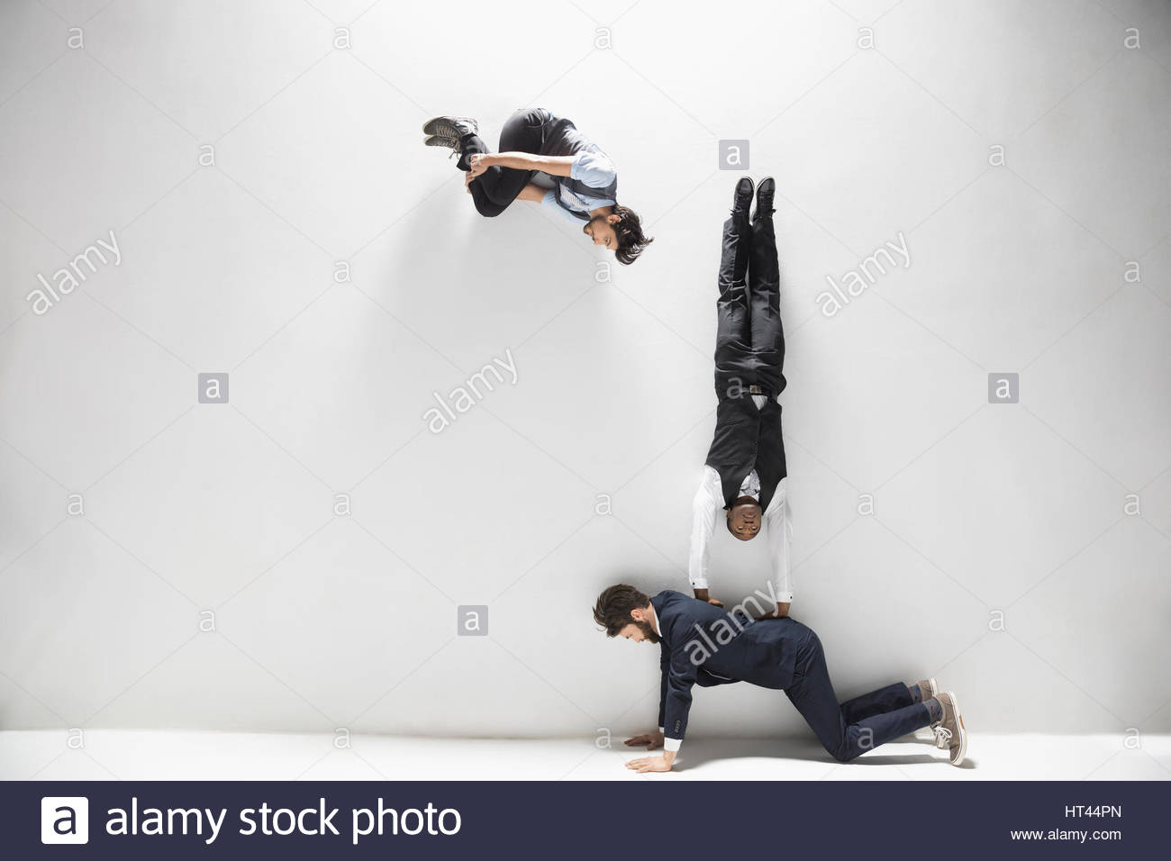 Business people balancing and flipping against white background Stock ...