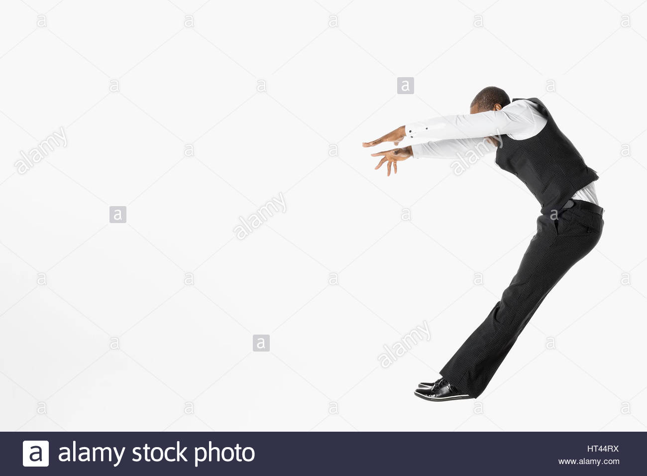 Businessman jumping, falling back against white background Stock Photo ...