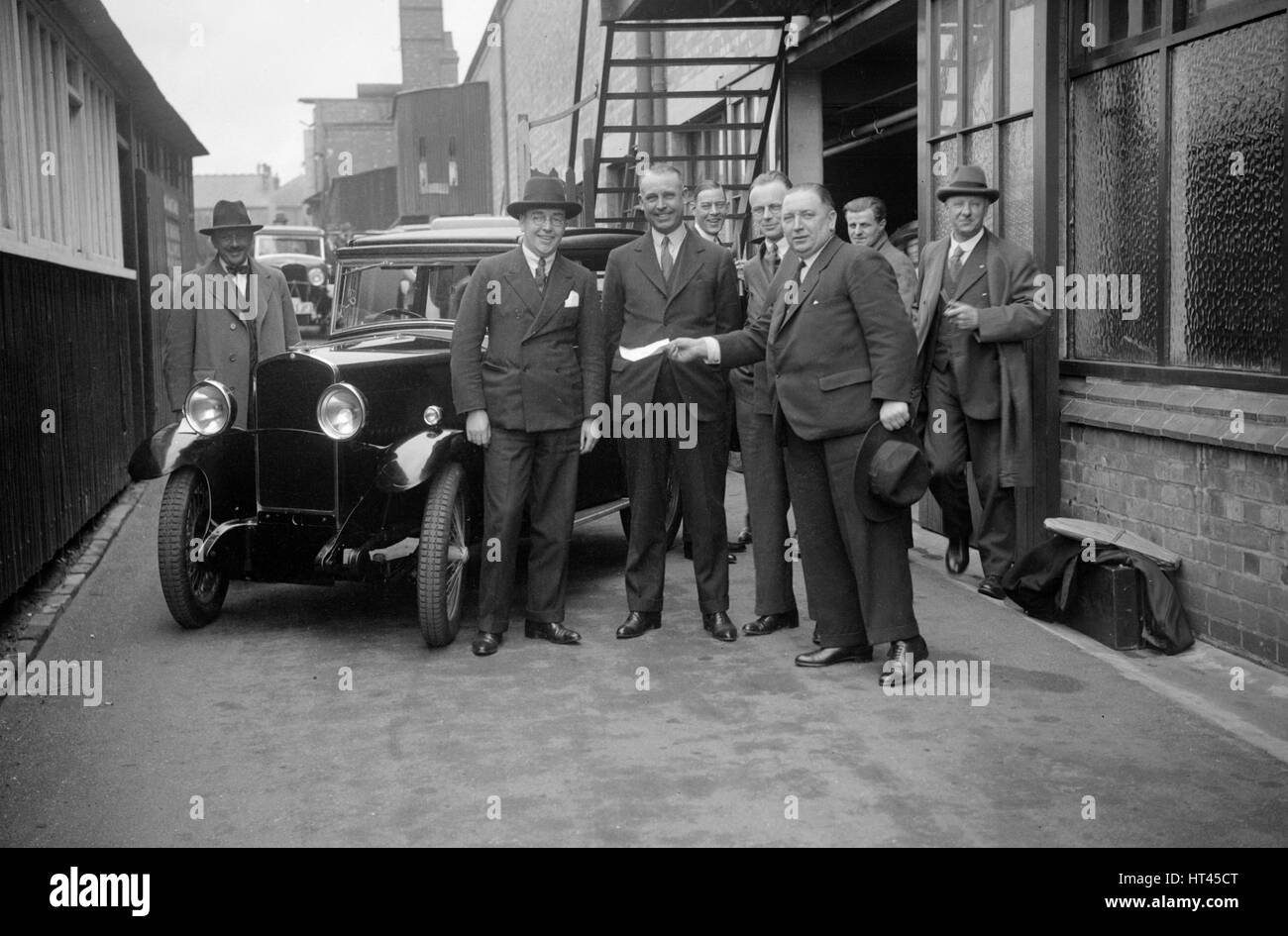 Group of men with a Triumph Super Seven, c1930(?). Artist: Bill Brunell ...