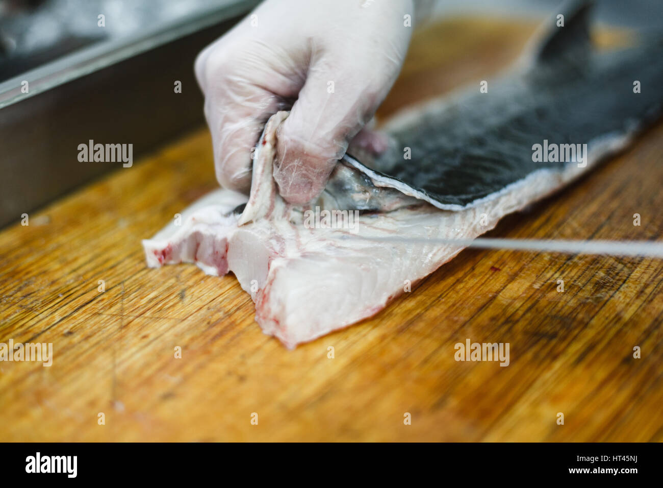 raw fish sturgeon cooking by professional on wooden desk Stock Photo ...