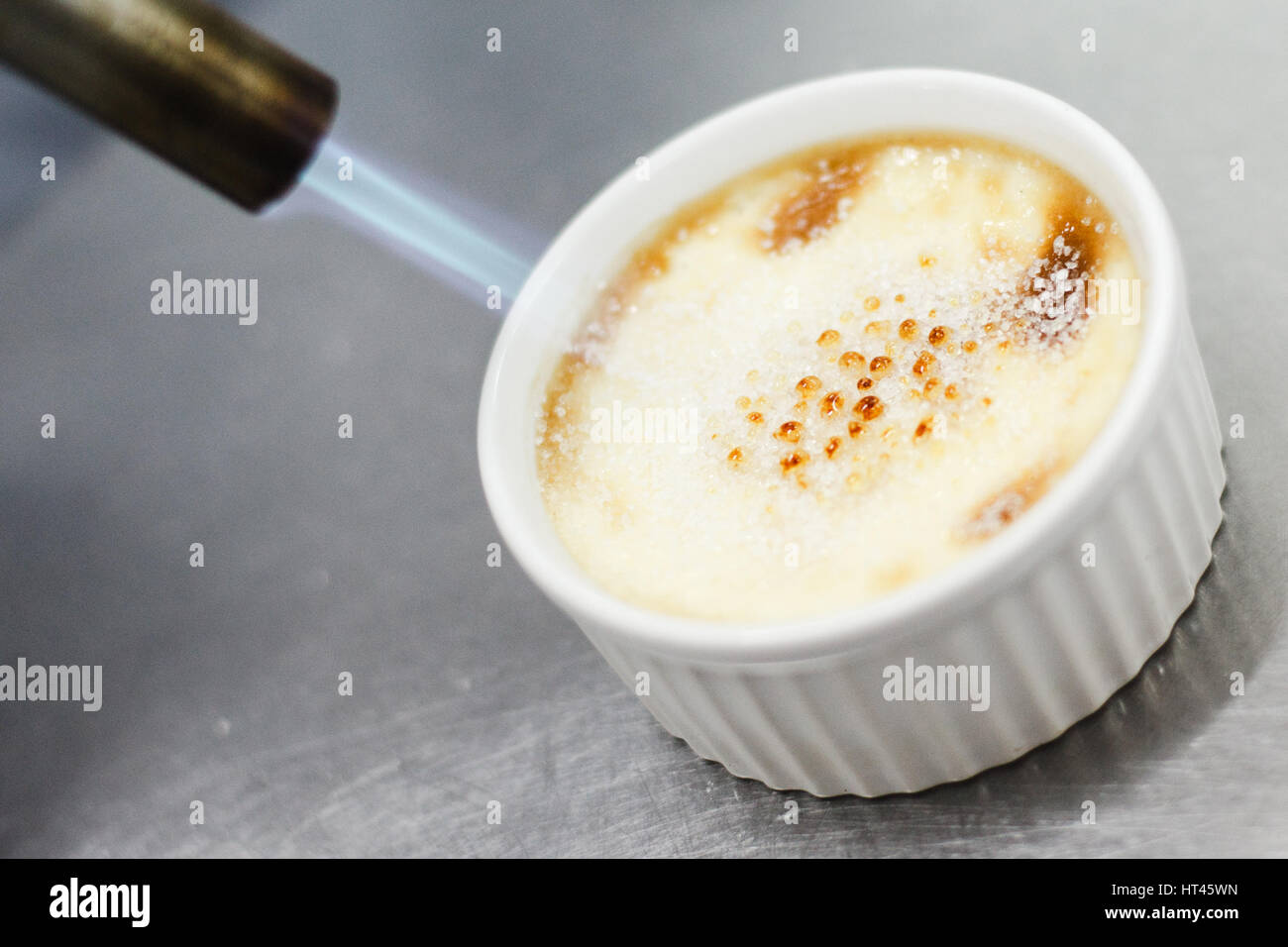 burn portion of creme brulee dessert on professional kitchen Stock ...