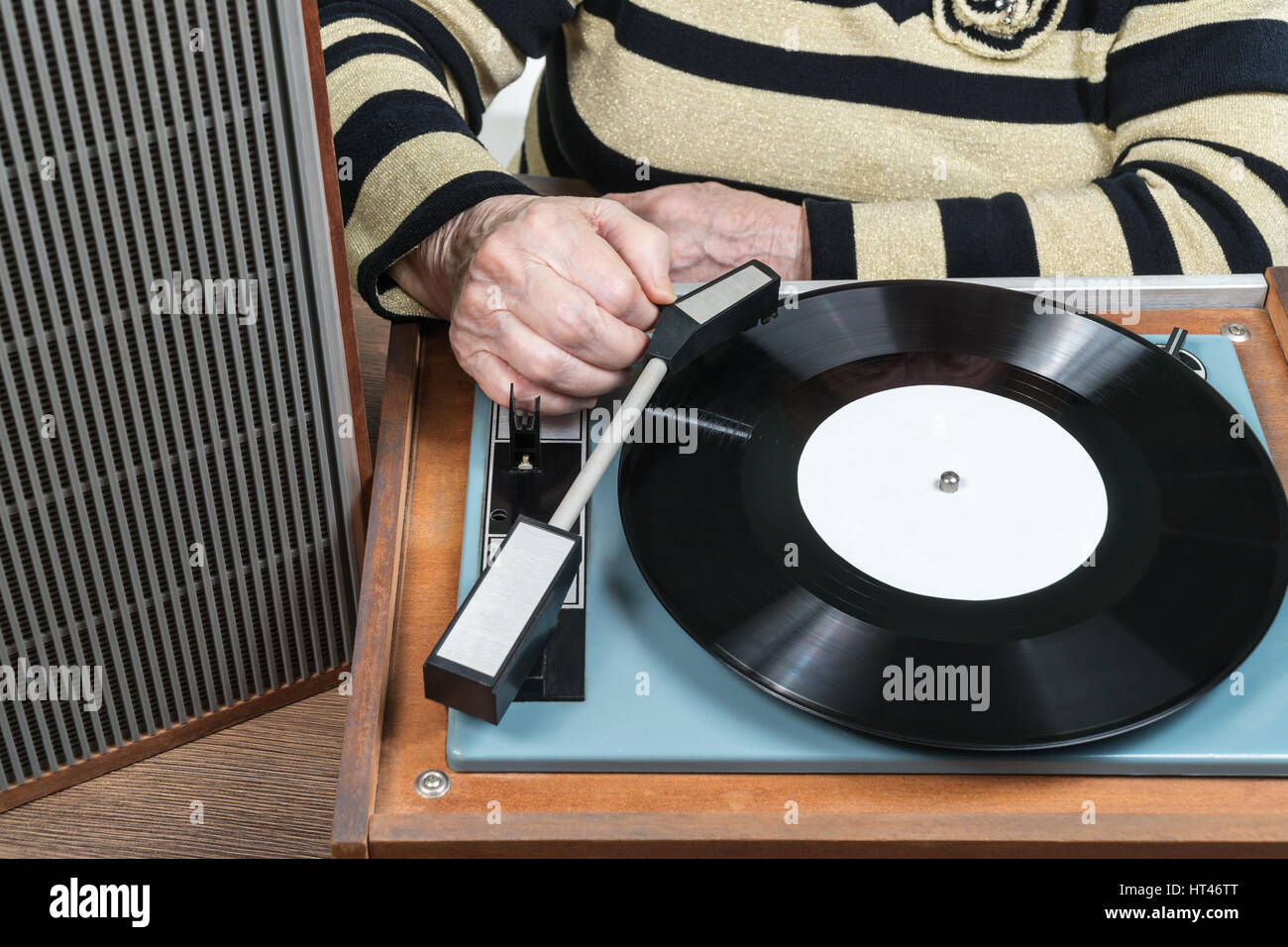 Old woman player includes, dropping the needle on the disc, close-up ...