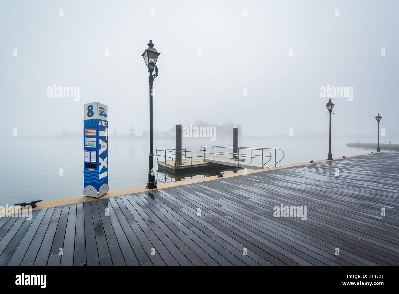The Waterfront Promenade and fog over the harbor, in Fells Point ...