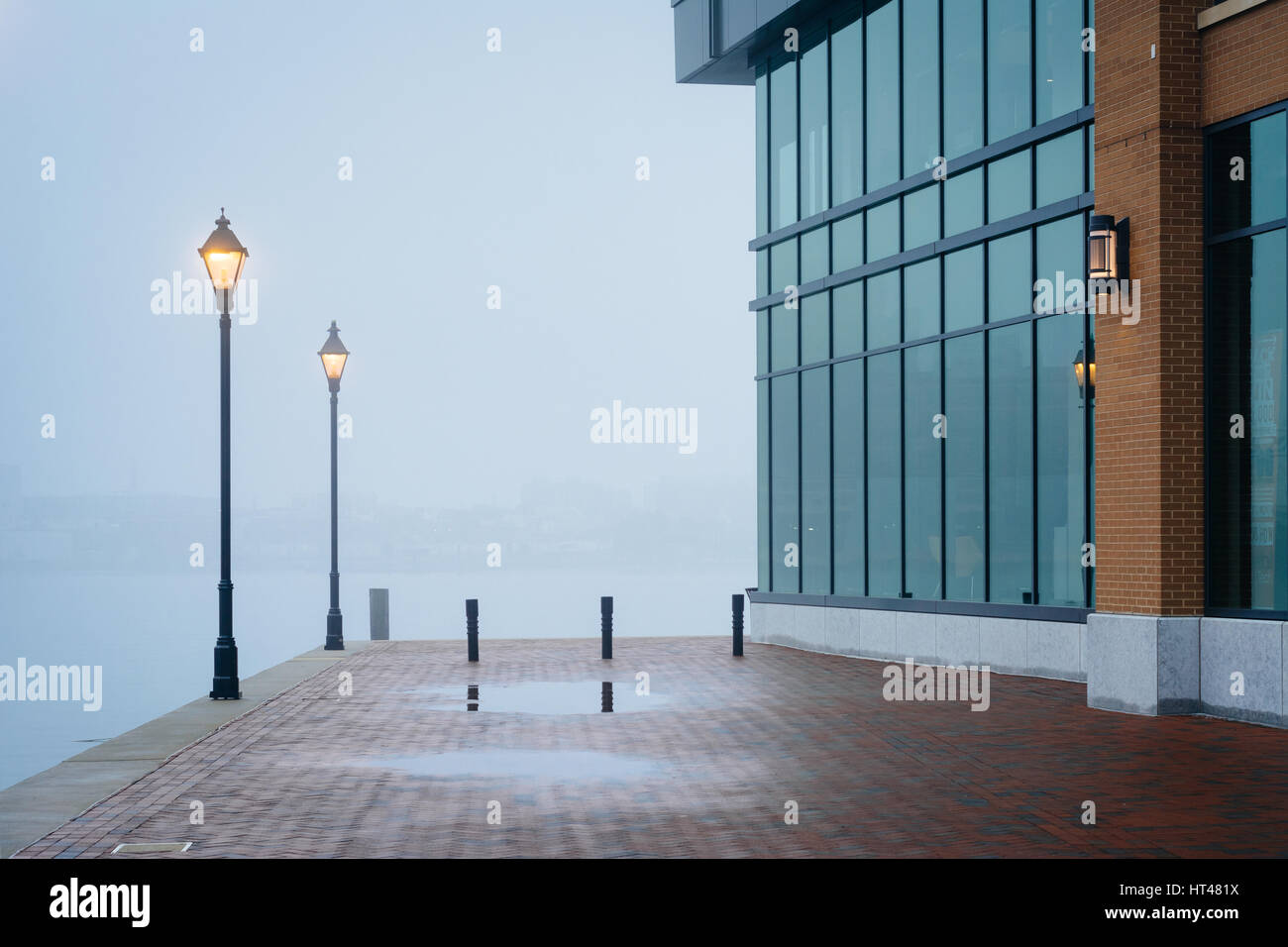 The Waterfront Promenade in fog and a modern building in Fells Point ...