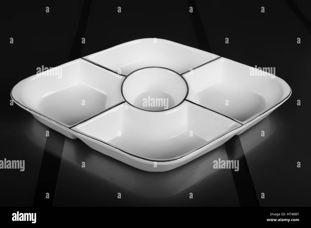 White shallow porcelain bowl with four compartments Stock Photo - Alamy