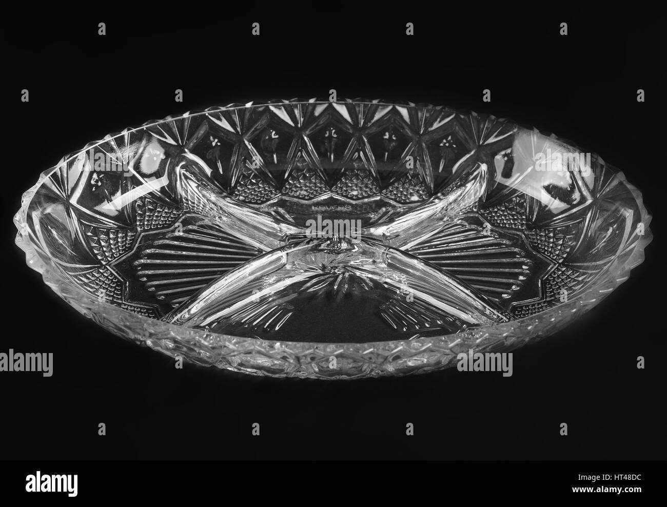 Shallow glass bowl with four compartments on black background Stock ...