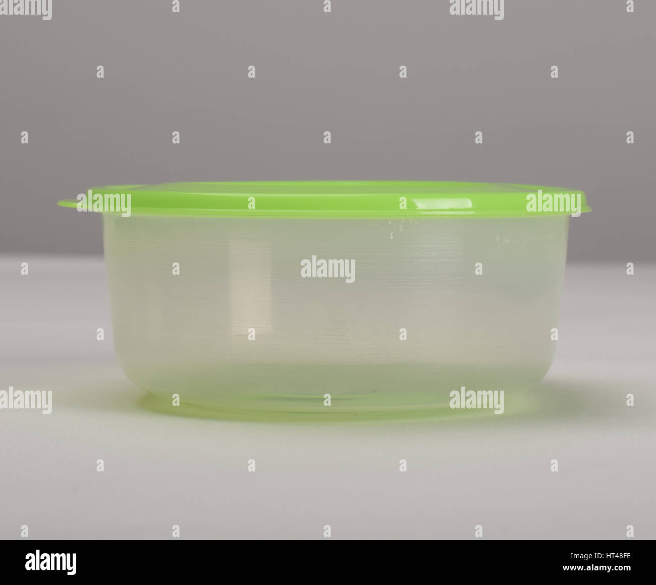 Round plastic container with green lid Stock Photo - Alamy