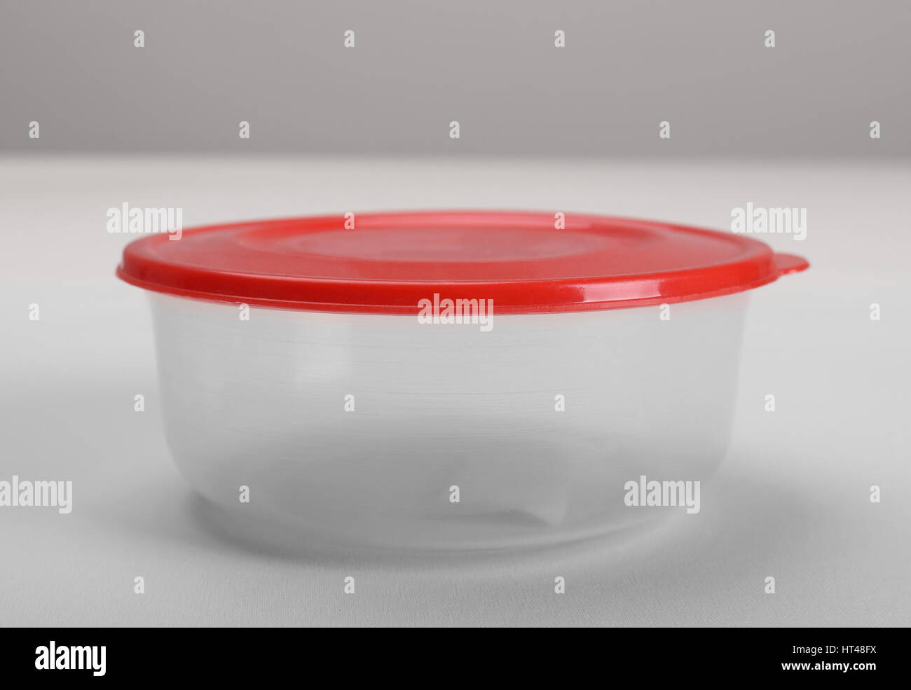 Round plastic container with red lid Stock Photo - Alamy