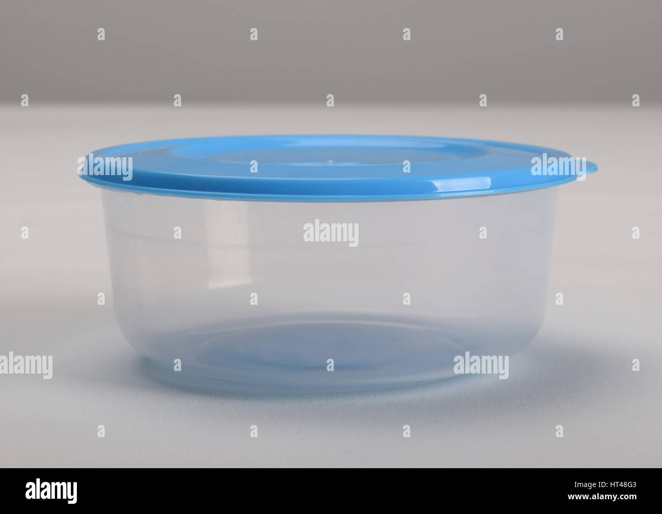 Round plastic container with blue lid Stock Photo - Alamy