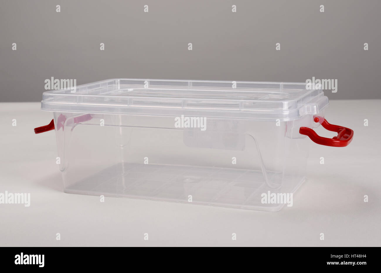 New plastic transparent box with handles and lid Stock Photo - Alamy