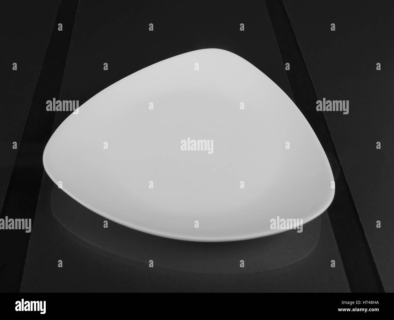 Triangular shallow porcelain bowl for serving food Stock Photo - Alamy