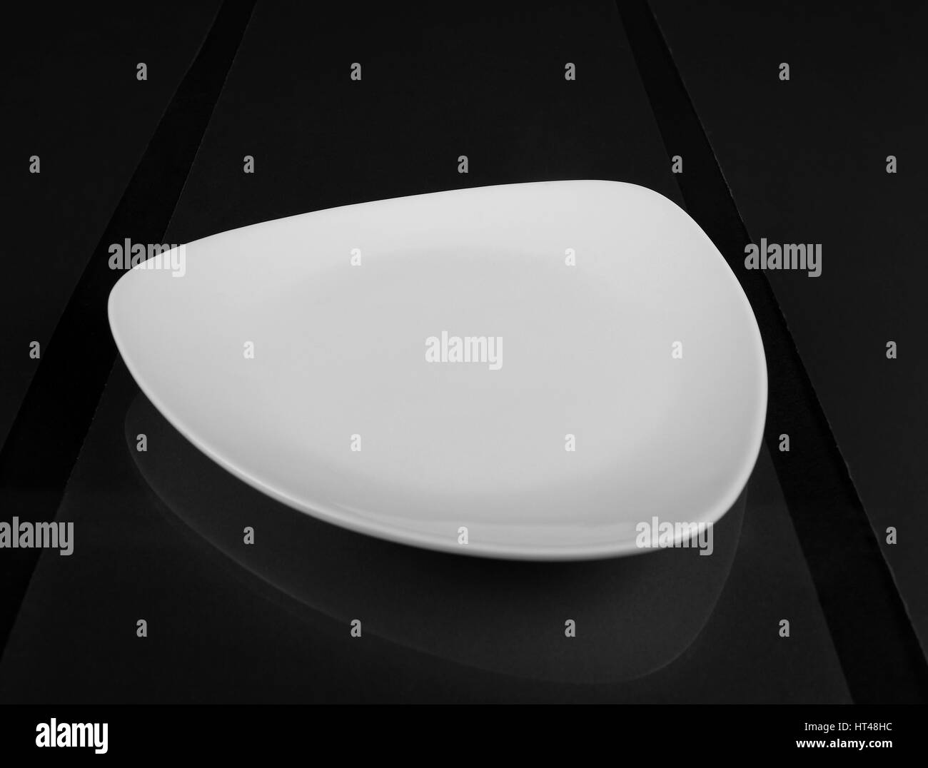 Triangular shallow porcelain bowl for serving food Stock Photo - Alamy