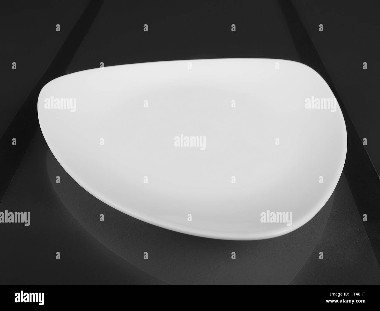 Triangular shallow porcelain bowl for serving food Stock Photo - Alamy