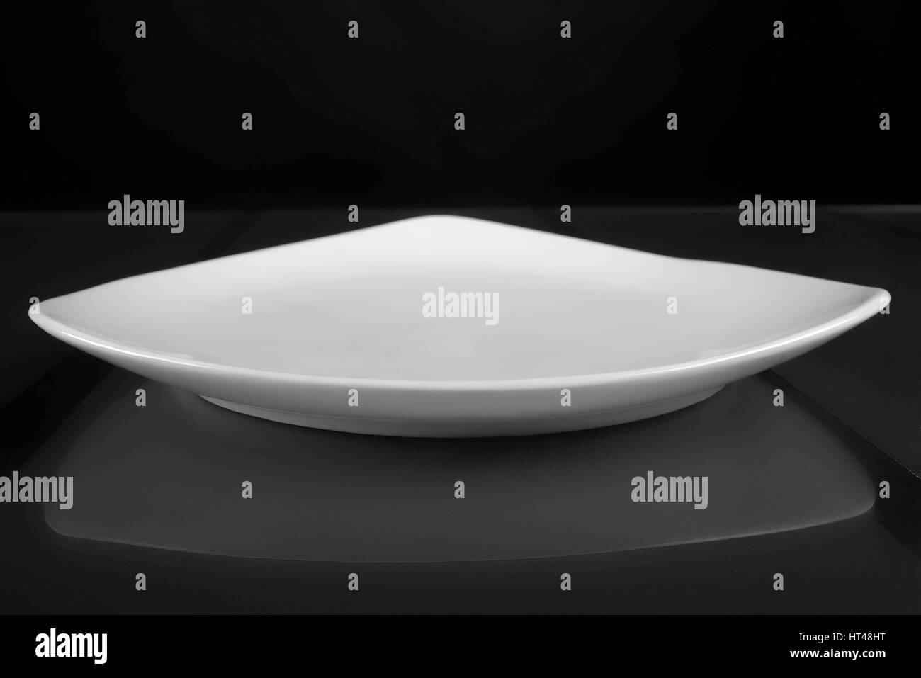 Triangular shallow porcelain bowl for serving food Stock Photo - Alamy