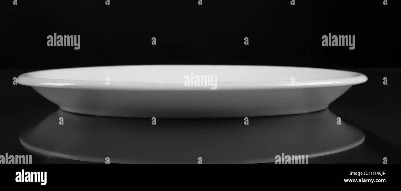 Porcelain round square shallow dish. Front view Stock Photo - Alamy