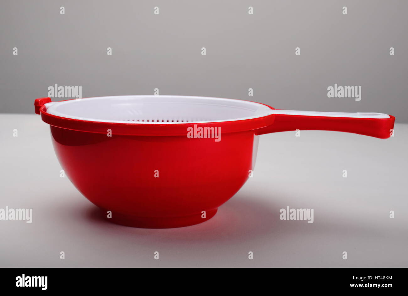Red plastic colander isolated on white background Stock Photo - Alamy
